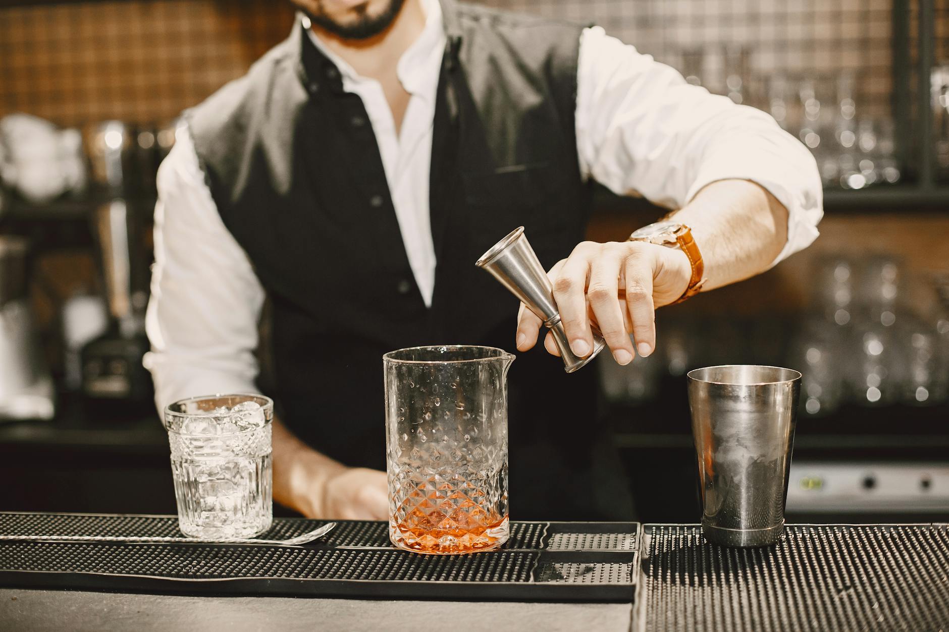Bartender preparing a cocktail at a Glasgow mixology bar